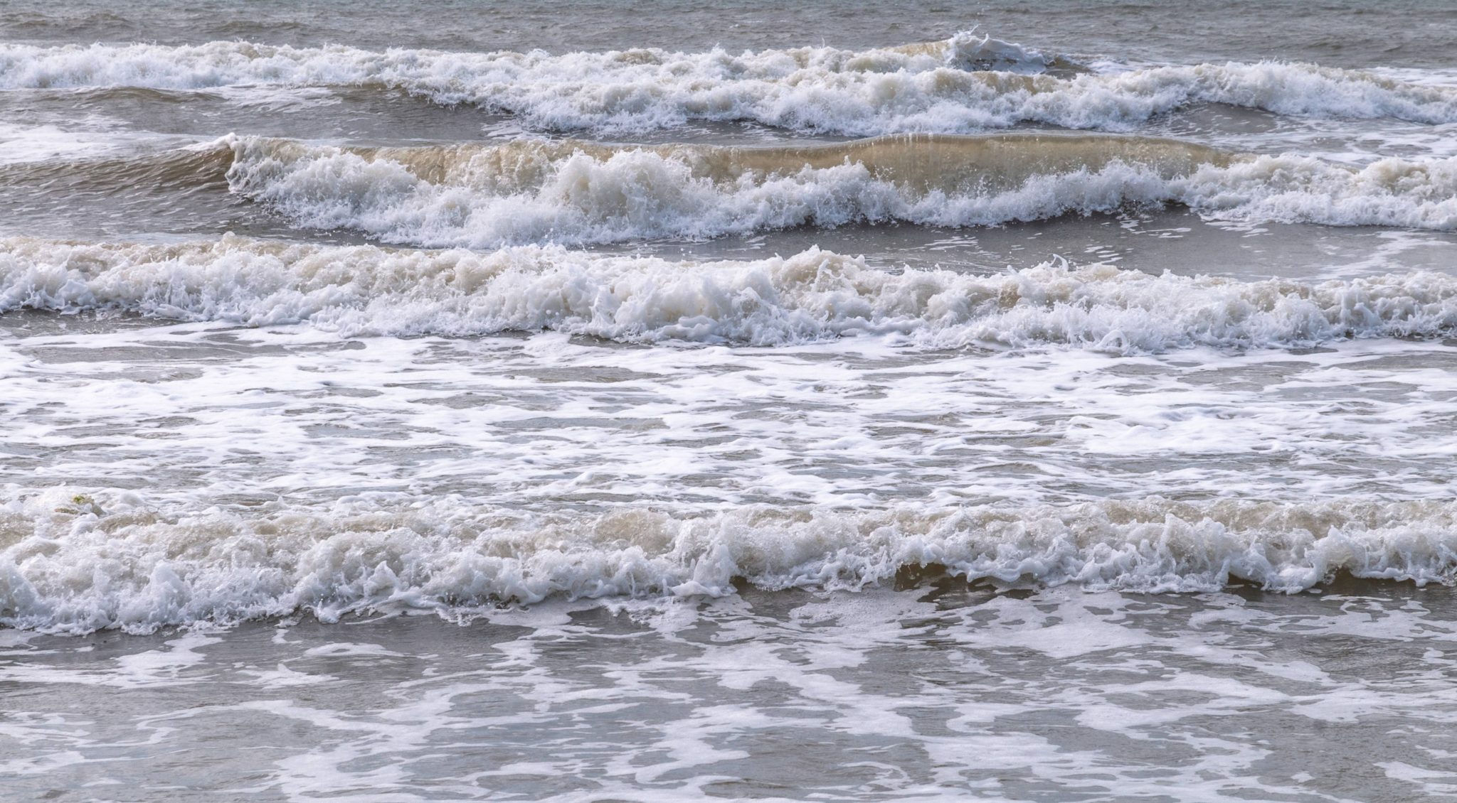 Foam waves at the beach sea background - PatternPictures
