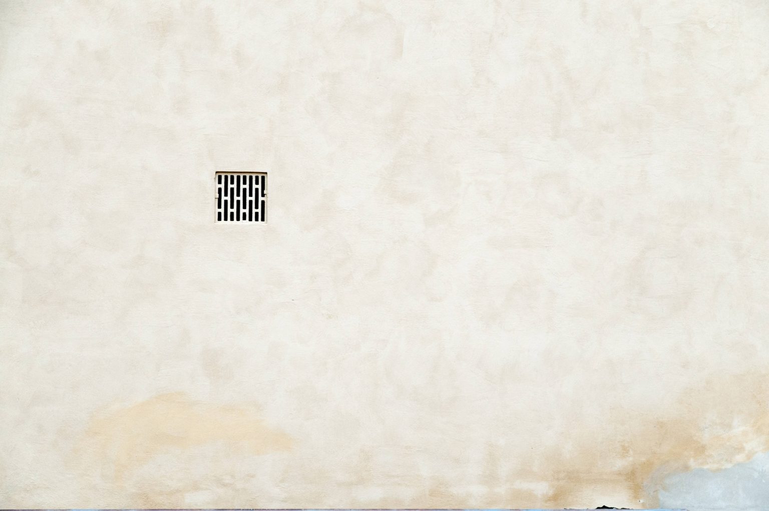 White stone wall with ventilation grate - PatternPictures